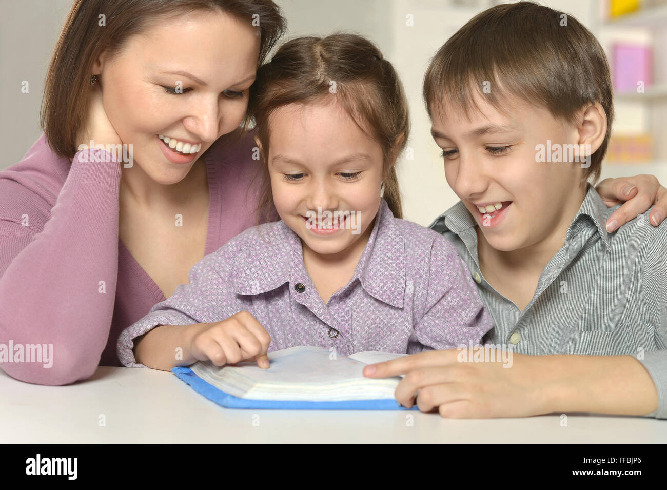 Mother help children Stock Photo - Alamy