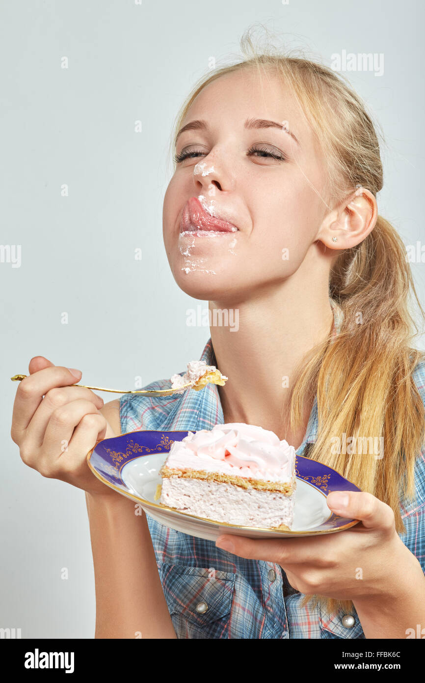happy fun girl eating sweet dessert Stock Photo - Alamy