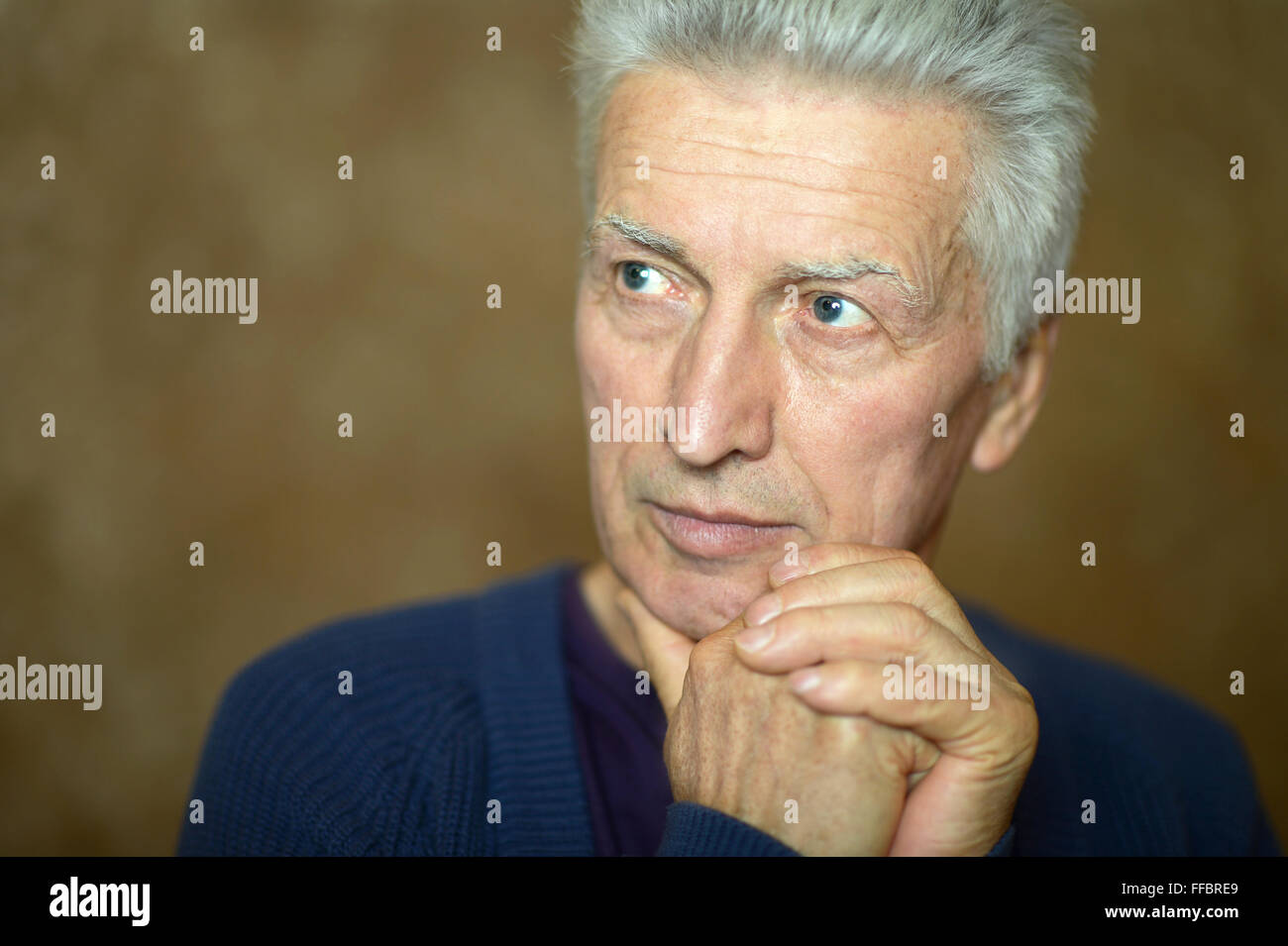 Pensive elderly man at home Stock Photo - Alamy