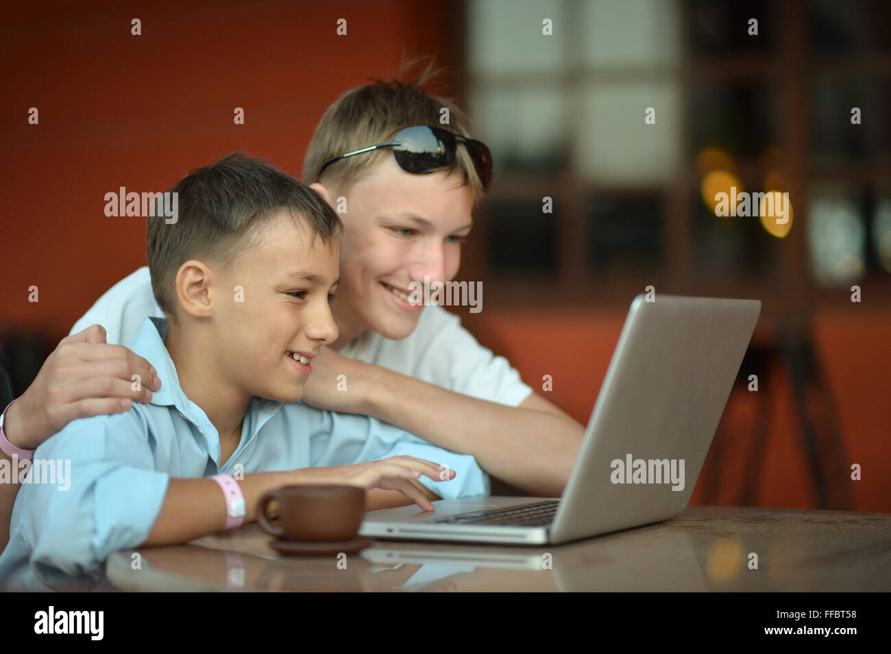 brothers with laptop Stock Photo - Alamy