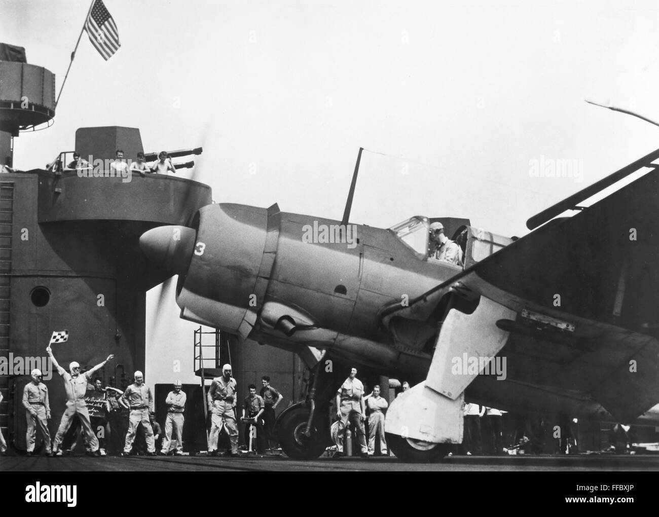 THE FIGHTING LADY, 1944. /nA take-off signal officer gives a fighter ...