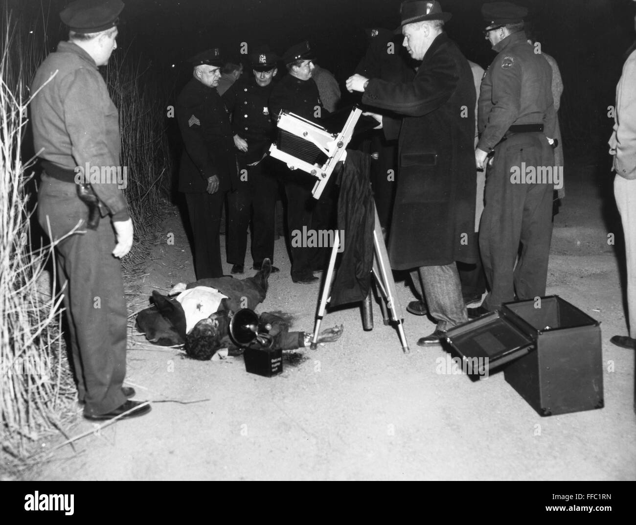 CRIME SCENE, 1959. /nA police photographer records the crime scene ...