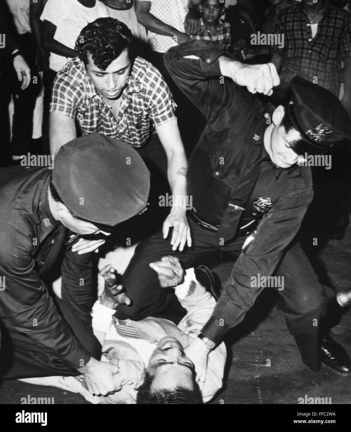 NYC: STREET FIGHT, 1961. /nPolicemen subdue a man among a group ...