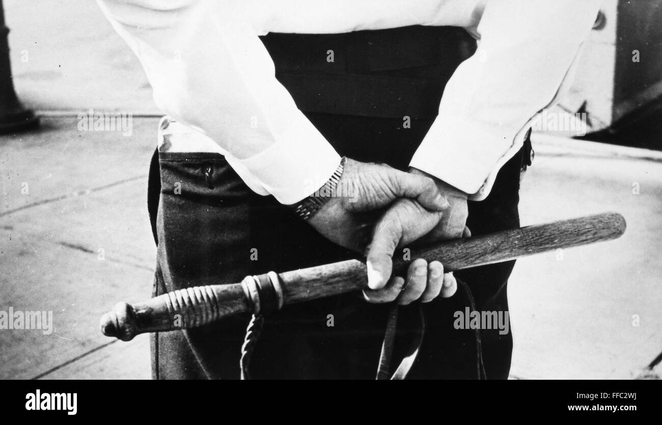 POLICE NIGHTSTICK. /nA Baltimore police officer on duty holding a ...