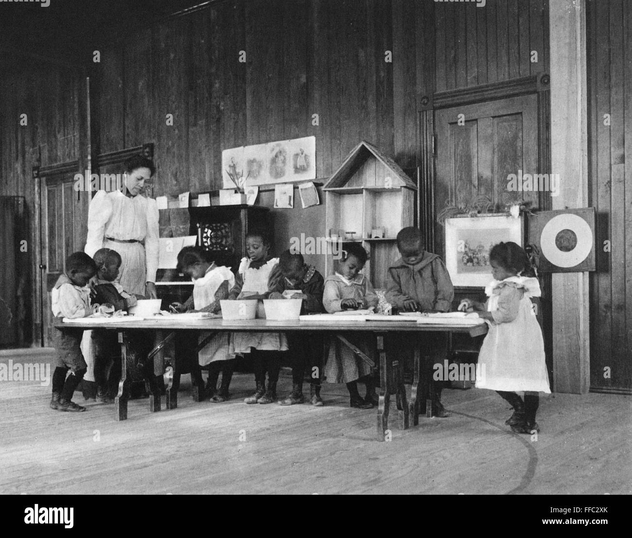 ELEMENTARY SCHOOL, c1900. /nKindergarten students washing and ironing ...
