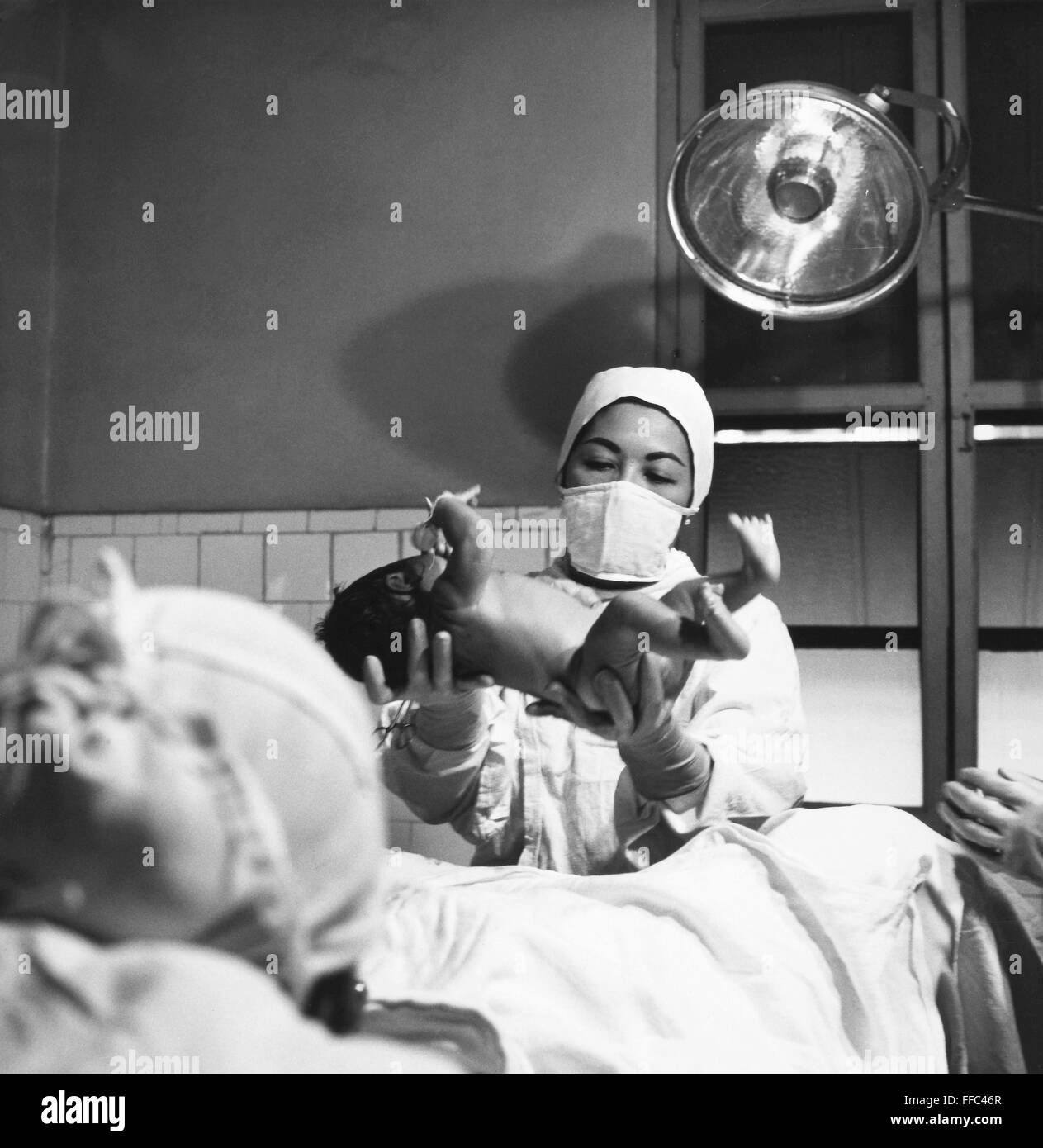 PHILIPPINES: CHILDBIRTH, 1959. /nDelivering a baby boy at a hospital in ...