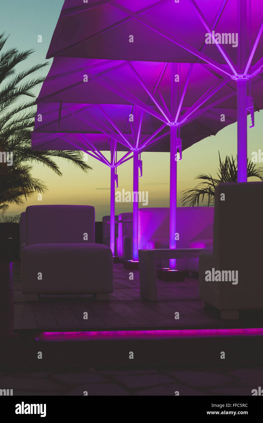 Bar terrace by night illuminated with neon lights Stock Photo - Alamy