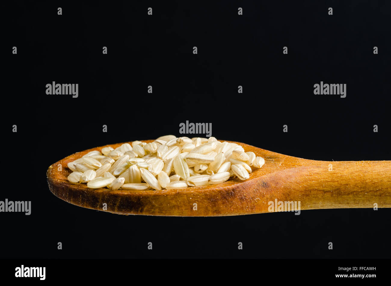 rice in a spoon, close up, color background Stock Photo - Alamy