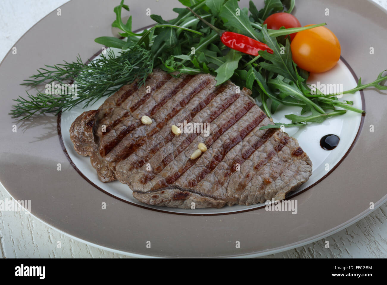 Grilled beaf steak with rucola and dill leaves Stock Photo - Alamy