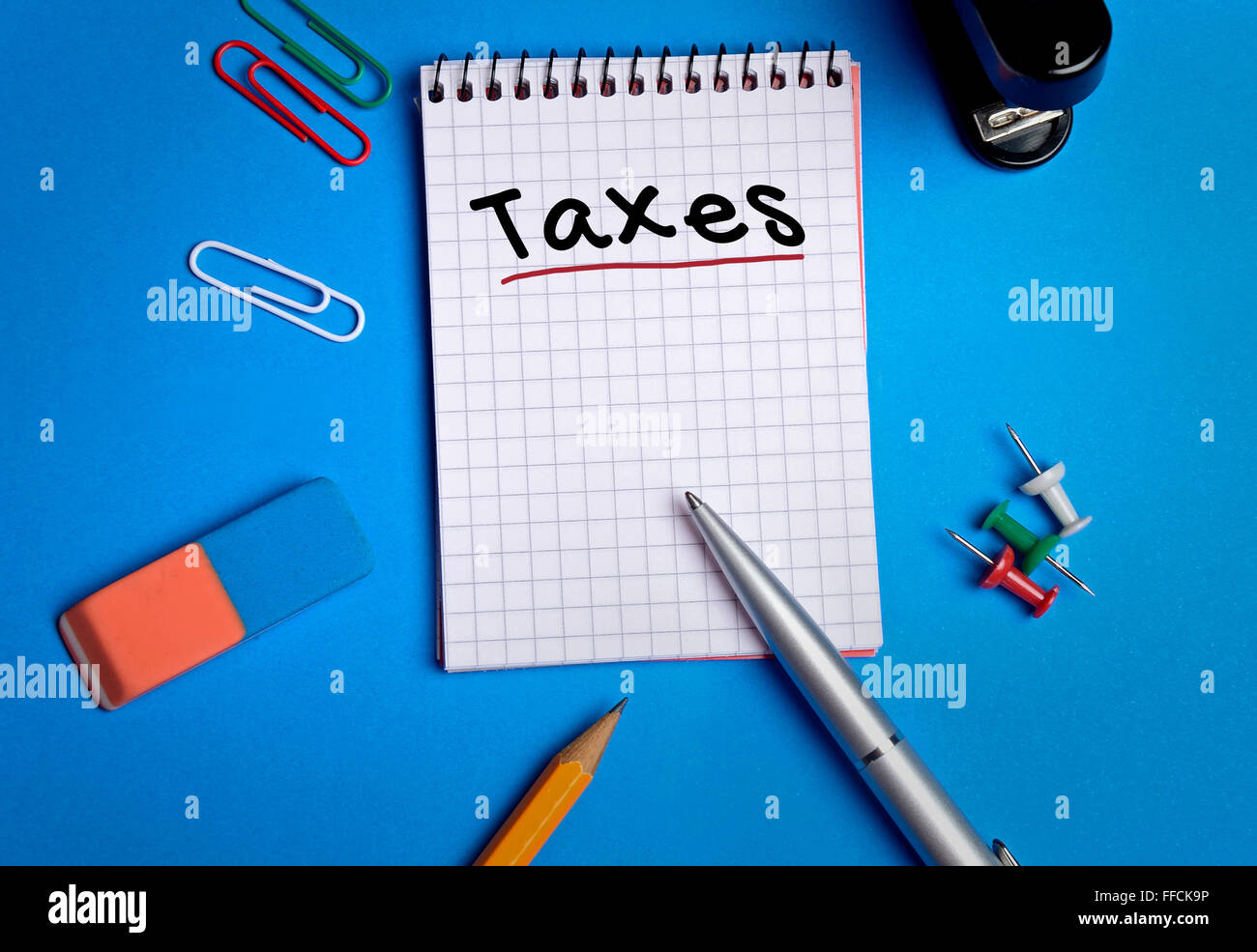 Taxes word on notebook page Stock Photo - Alamy