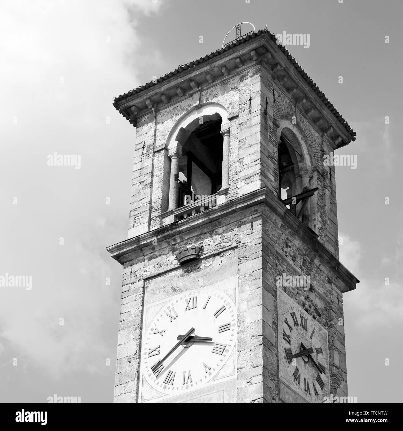 ancien clock tower in italy europe old stone and bell Stock Photo - Alamy