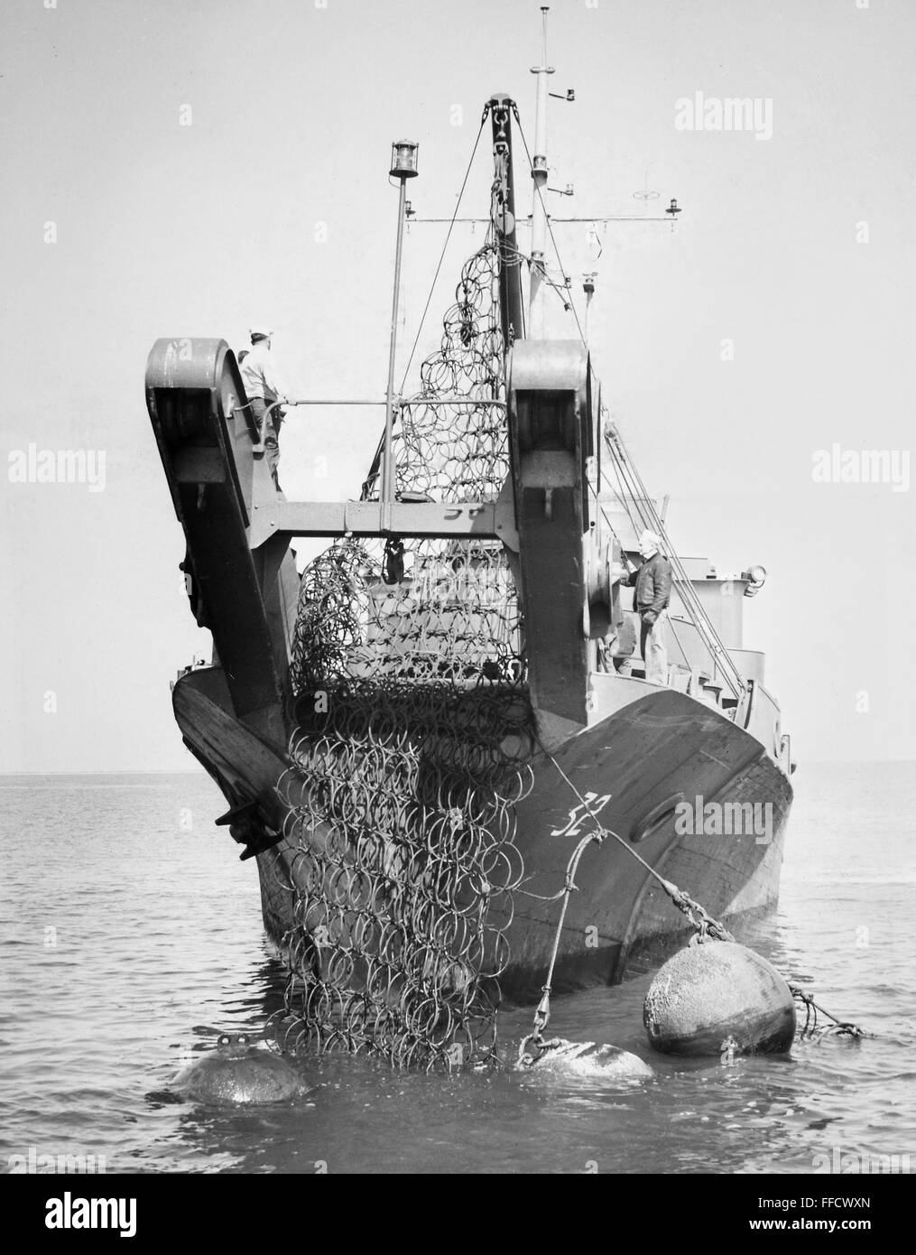 WORLD WAR II: TORPEDO NET. /nU.S. Navy mine layer ship picking up an ...