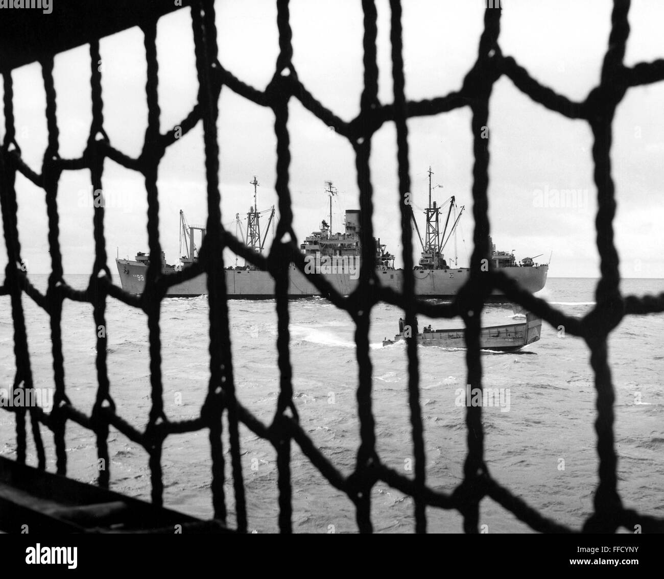 ARMY CARGO SHIPS, 1953. /nA U.S. Army attack cargo ship is framed by ...