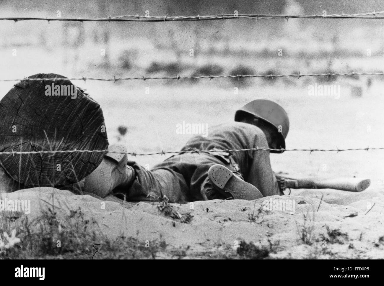 MILITARY TRAINING. /nA soldier training on an infiltration course, mid ...