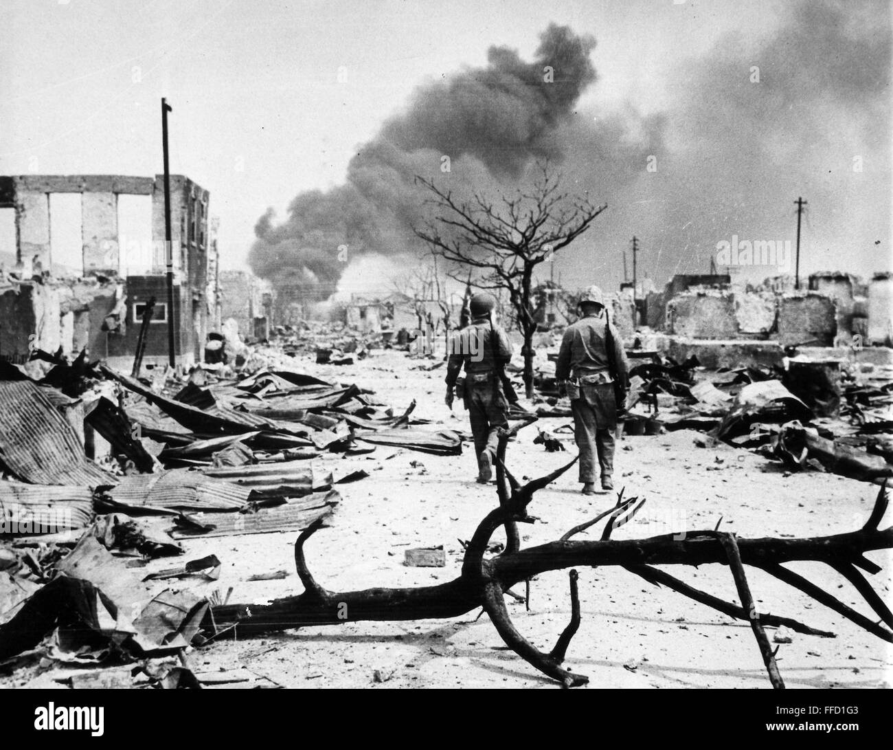 WORLD WAR II: PACIFIC. /nTwo U.S. Marines walking through rubble in an ...