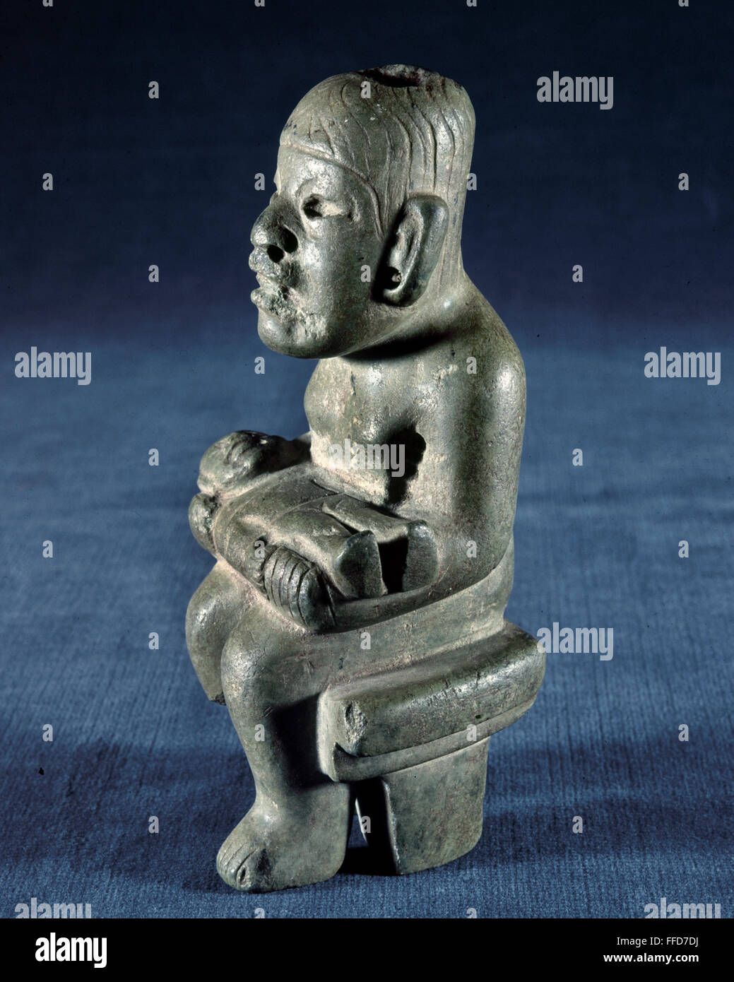 MEXICO: OLMEC FIGURE. /nSeated figure holding a child. Carved stone ...