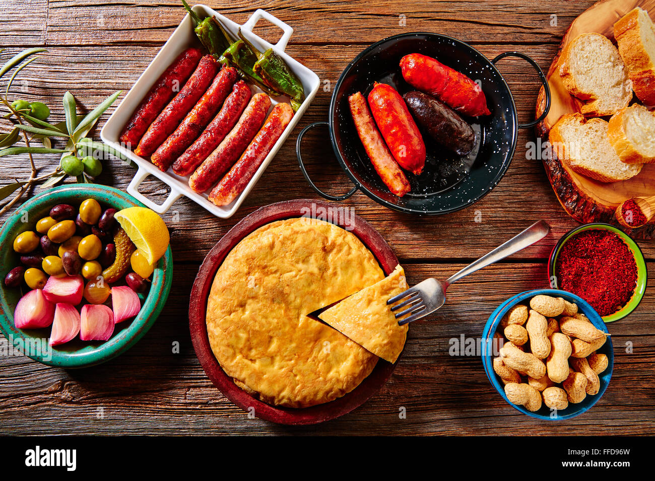 Tapas mix spanish potatoes omelette sausage olives bread and paprika ...
