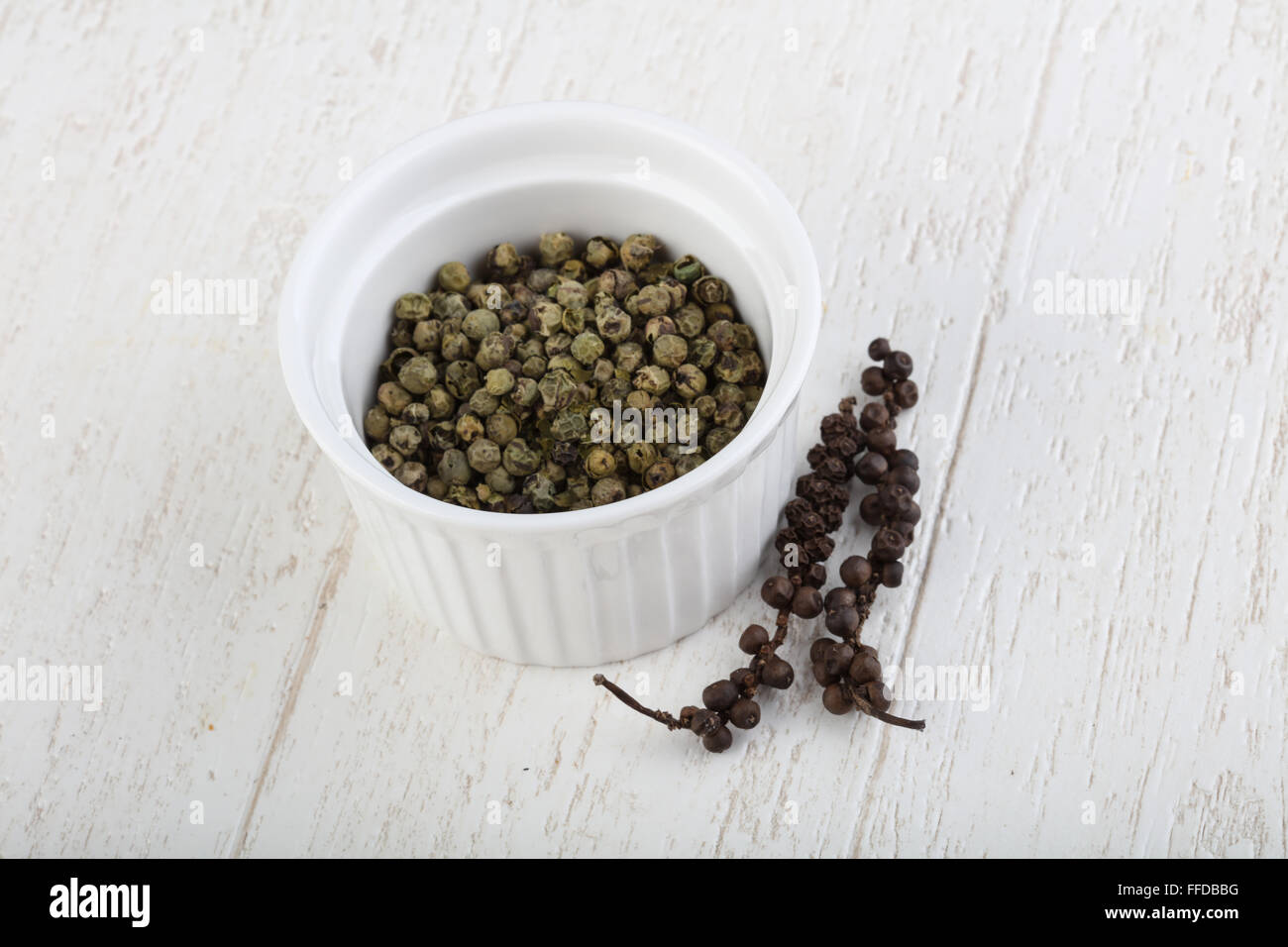 Dry Green pepper corn on the wood background Stock Photo - Alamy