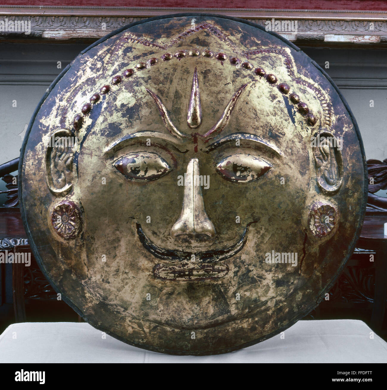 INDIAN SHIELD. /nIndian shield with a face in relief Stock Photo - Alamy