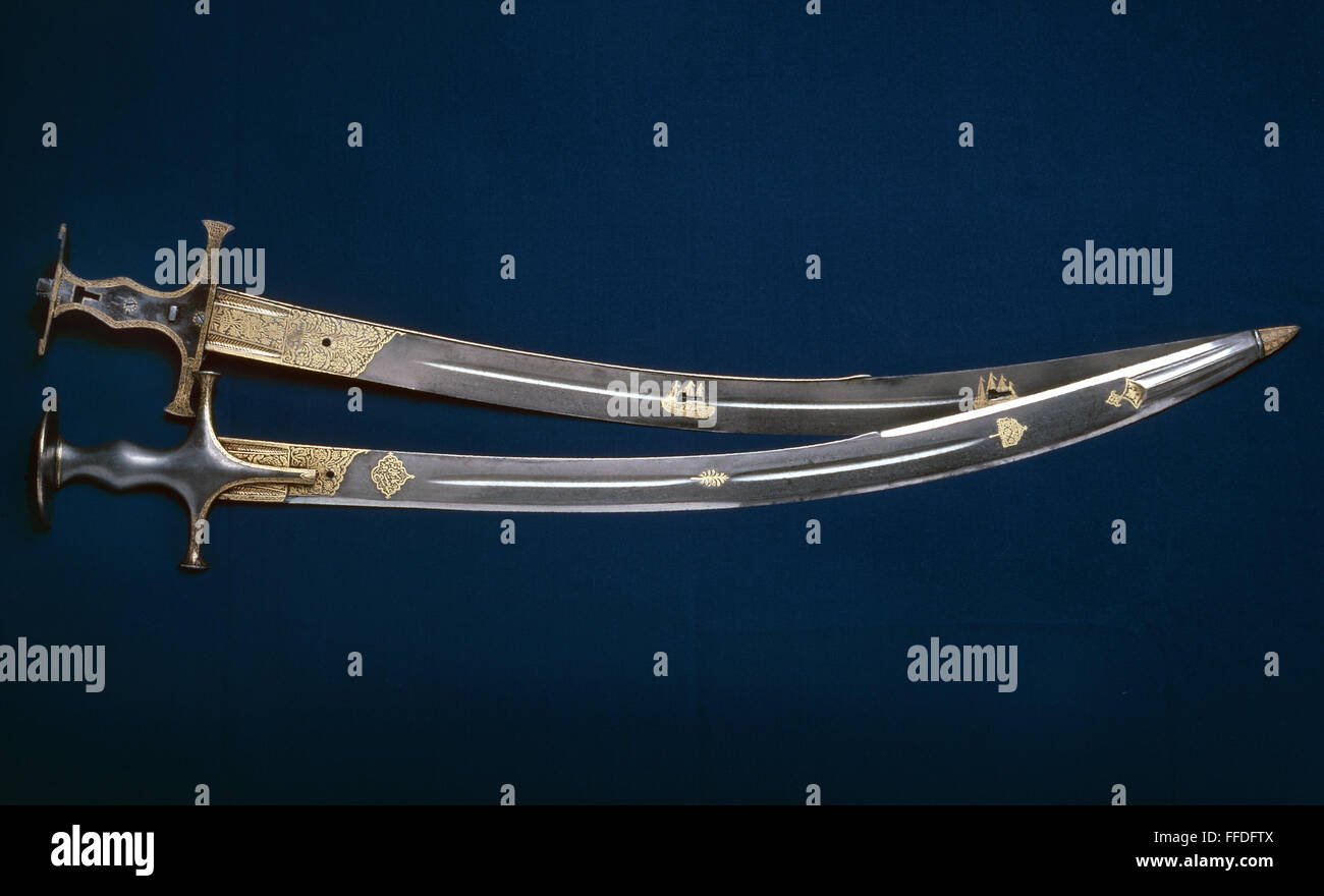 INDIAN SWORDS. /nPair of curved Indian swords with gold decoration ...