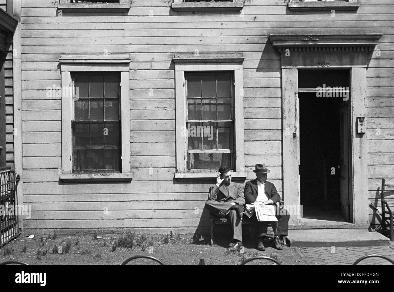 WASHINGTON SLUM, 1937. /nMen sitting in front of a house in a slum ...