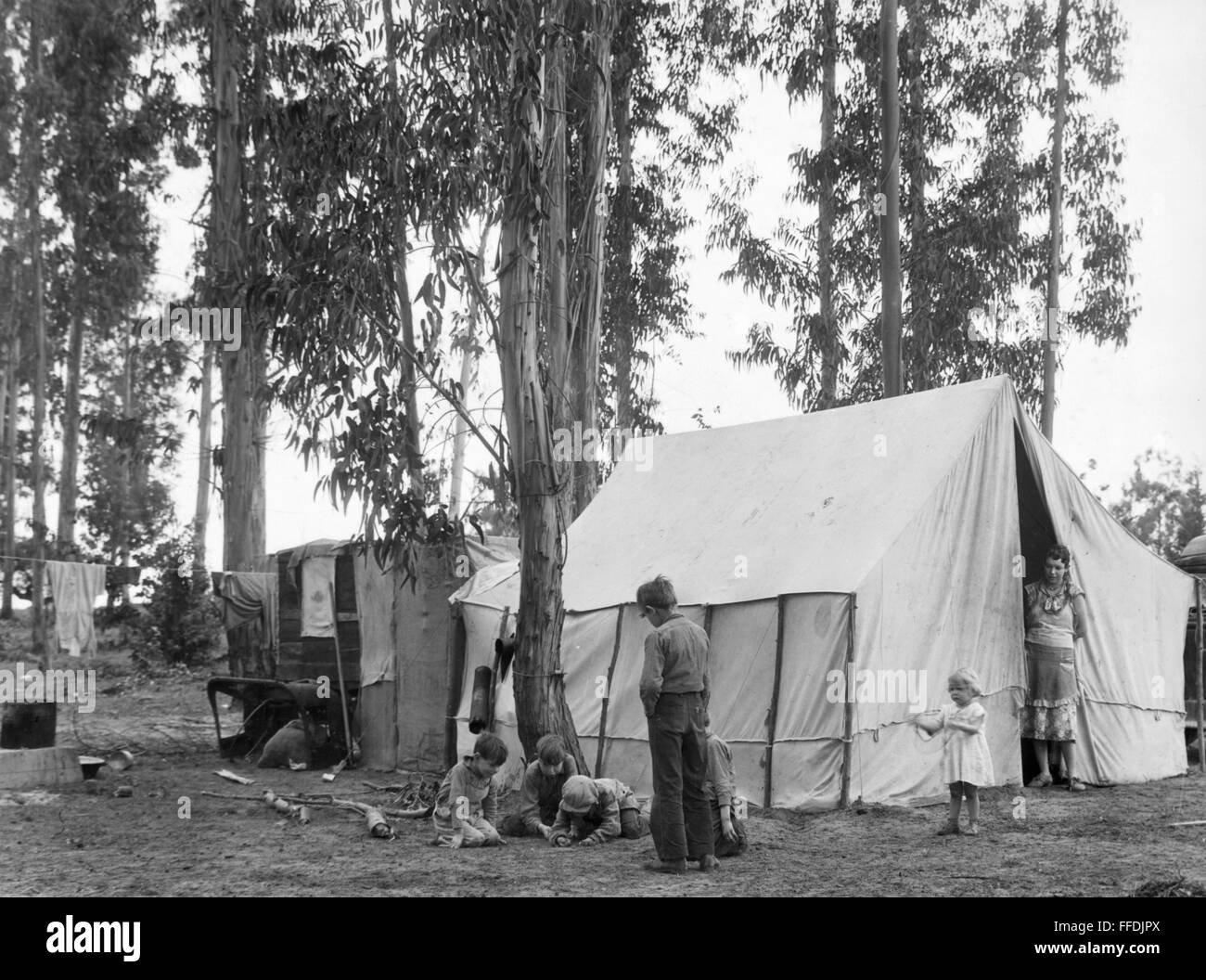 MIGRANT WORKER CAMP, 1935. /nA group of children playing in front of ...