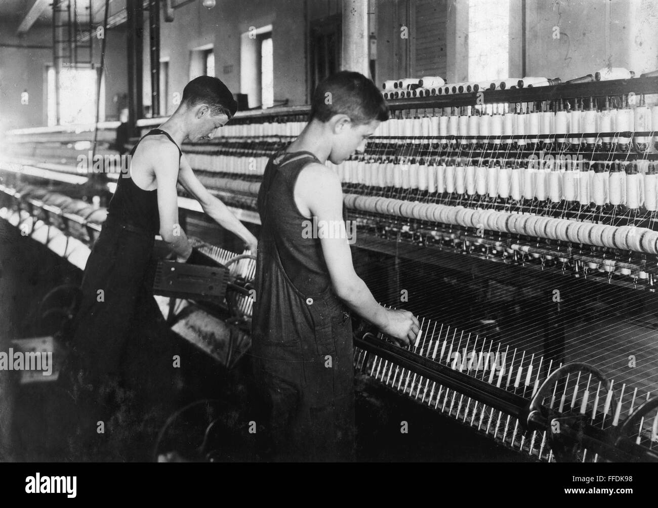 HINE: CHILD LABOR, 1916. /nTwo boys spinning at the textile mill in ...