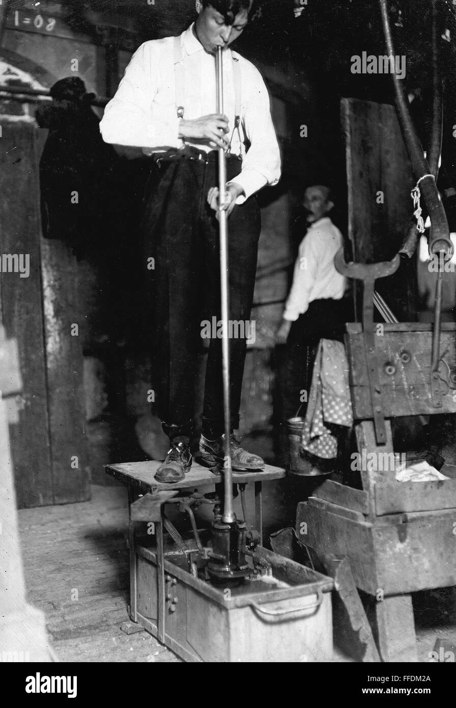 HINE: GLASS BLOWER, 1908. /nA glass blower with a foot mold at the ...