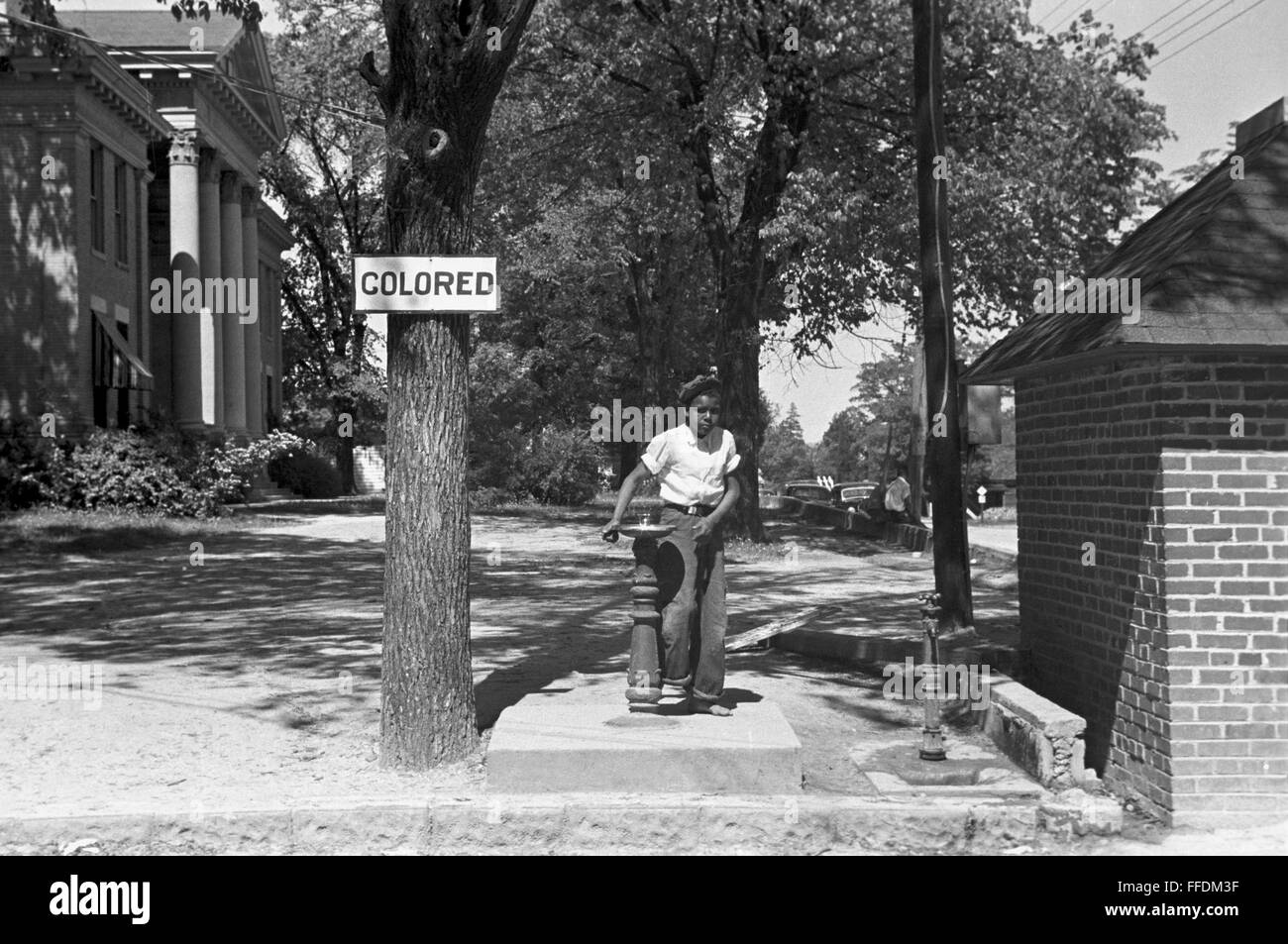 SEGREGATED FOUNTAIN, 1938. /nA boy drinking from a segregated water ...