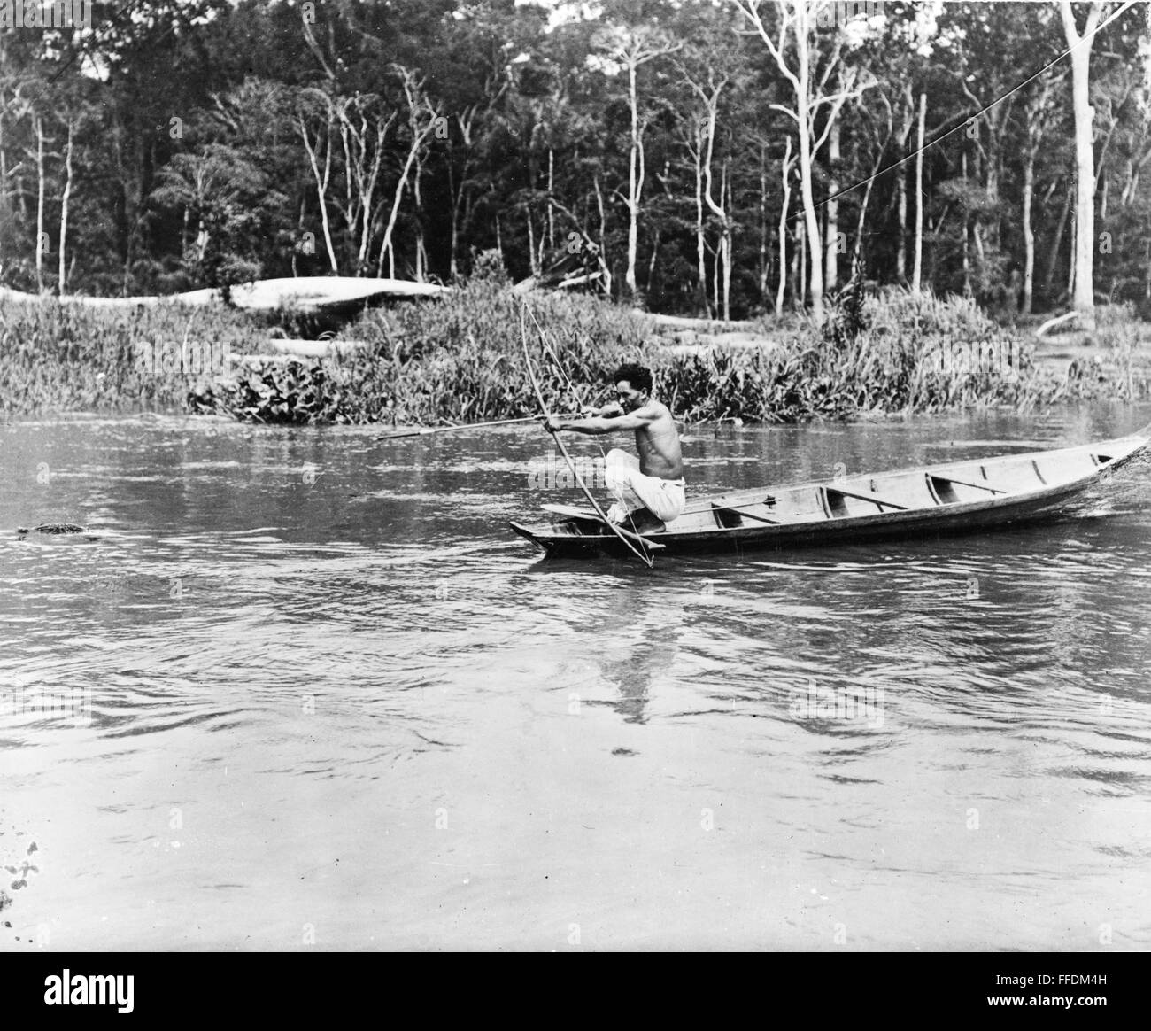 BRAZIL: AMAZON FISHING. /nA native Brazilian shooting fish from a canoe ...
