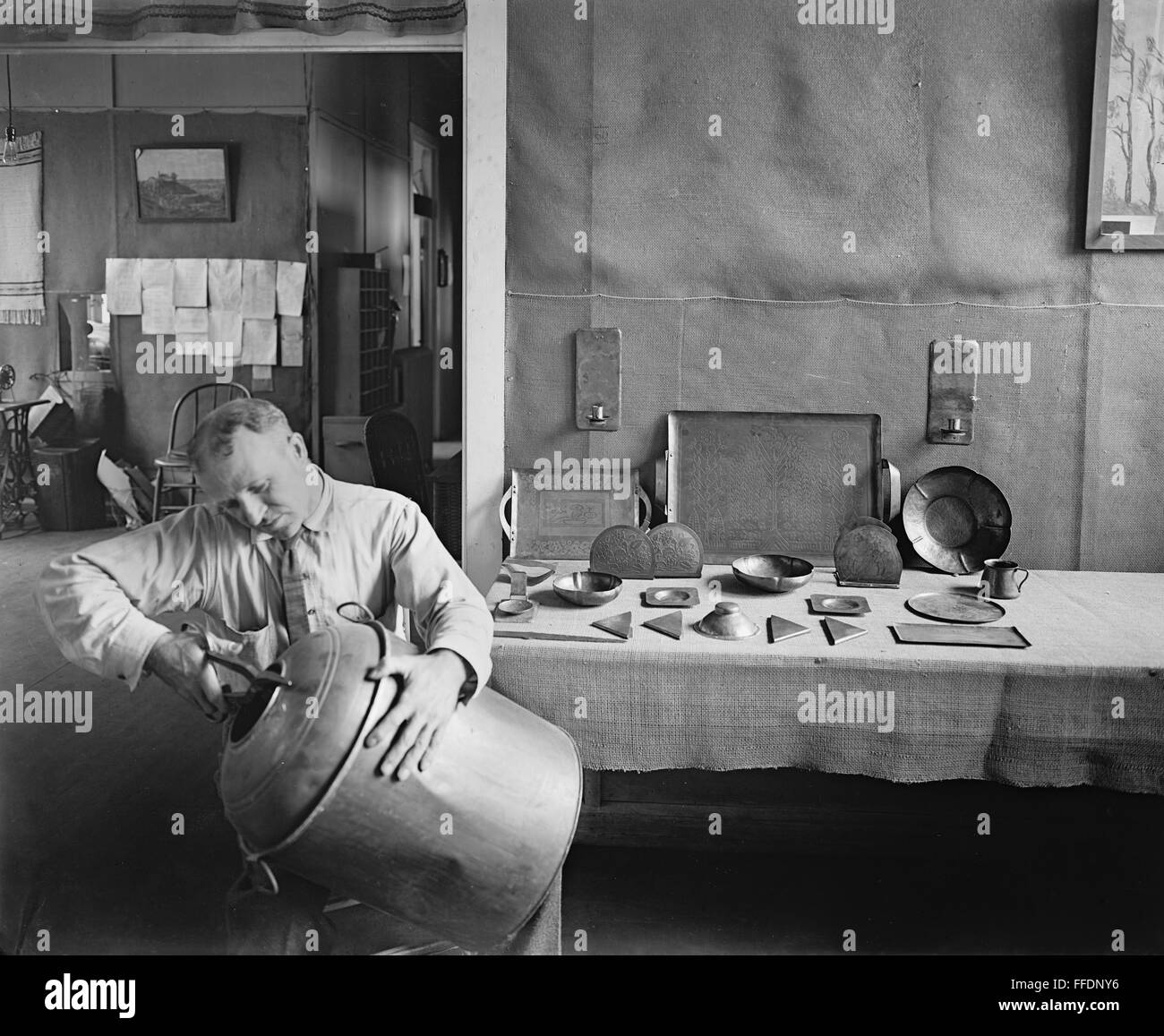 PROHIBITION, 1920s. /nA man cutting up confiscated bootleg liquor kegs ...