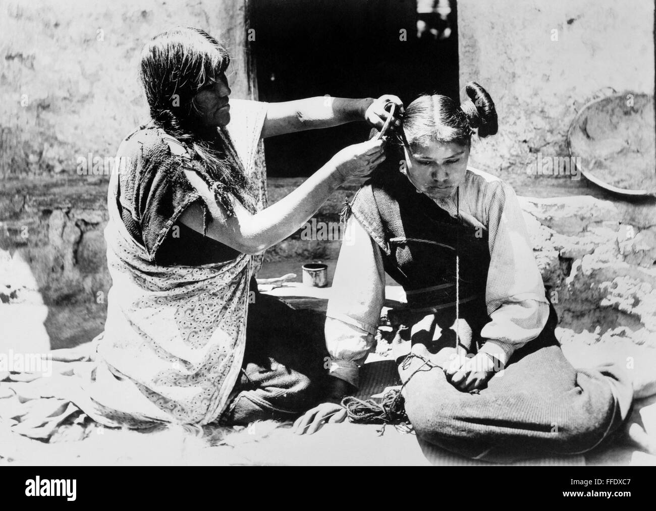 HOPI HAIR DRESSER, c1909. /nA Hopi woman combing and arranging the hair ...