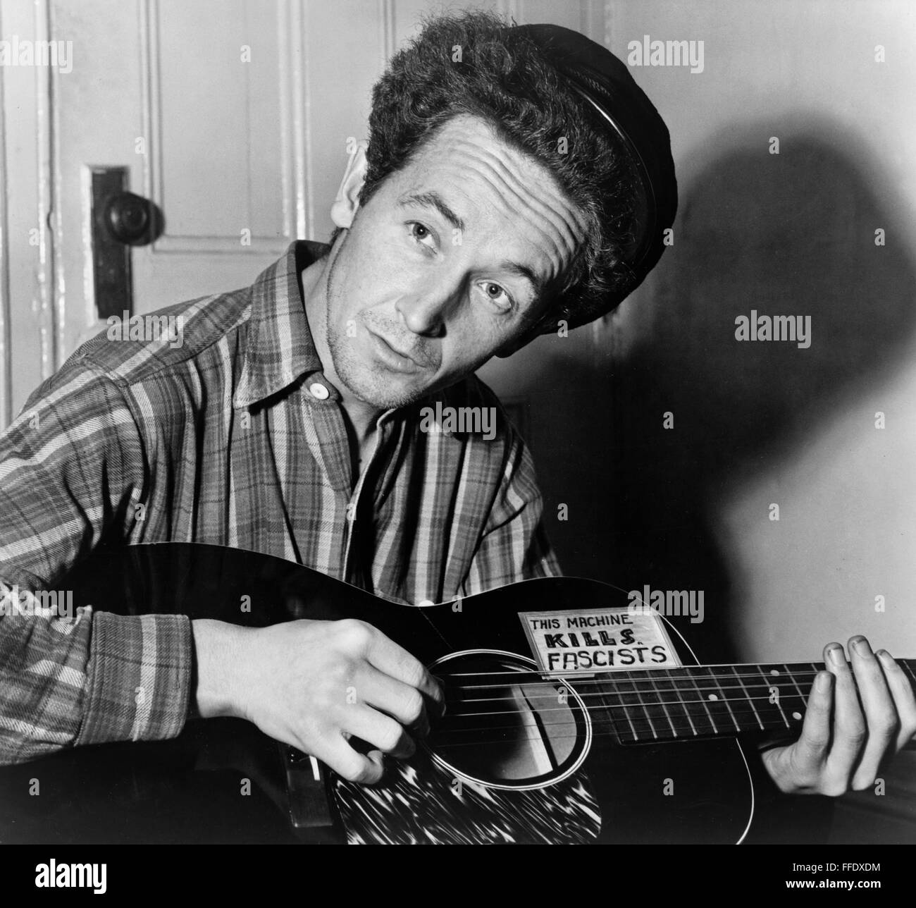 WOODY GUTHRIE (1912-1967). /nAmerican folk singer. Photographed playing ...