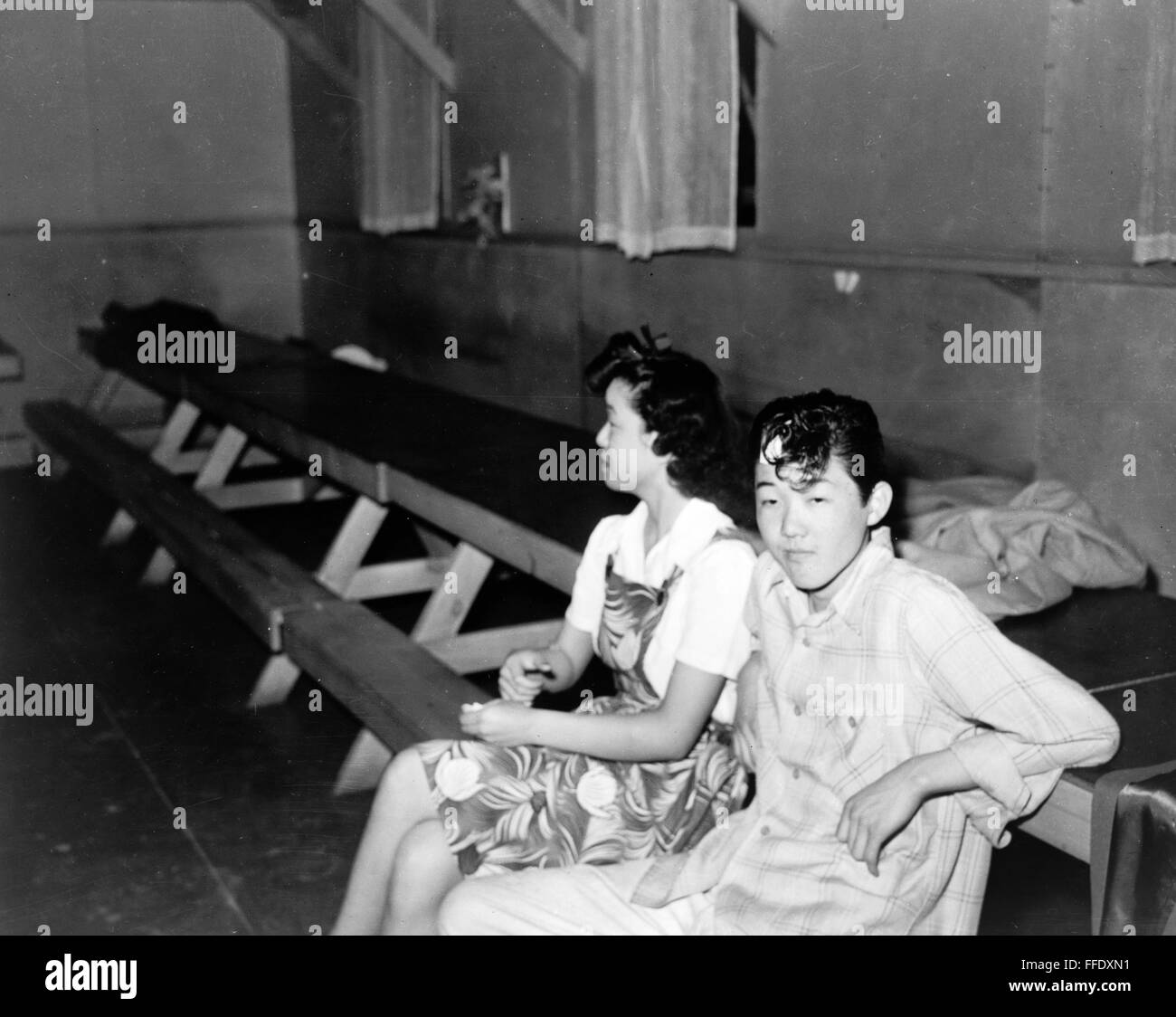 JAPANESE INTERNMENT, 1943. /nTwo women seated in a dining hall at a ...