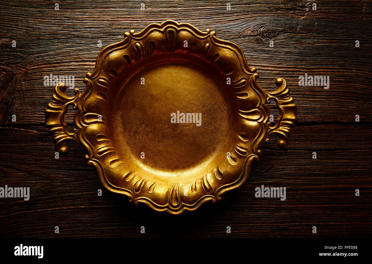 Vintage golden tray round on an aged brown wood background Stock Photo ...