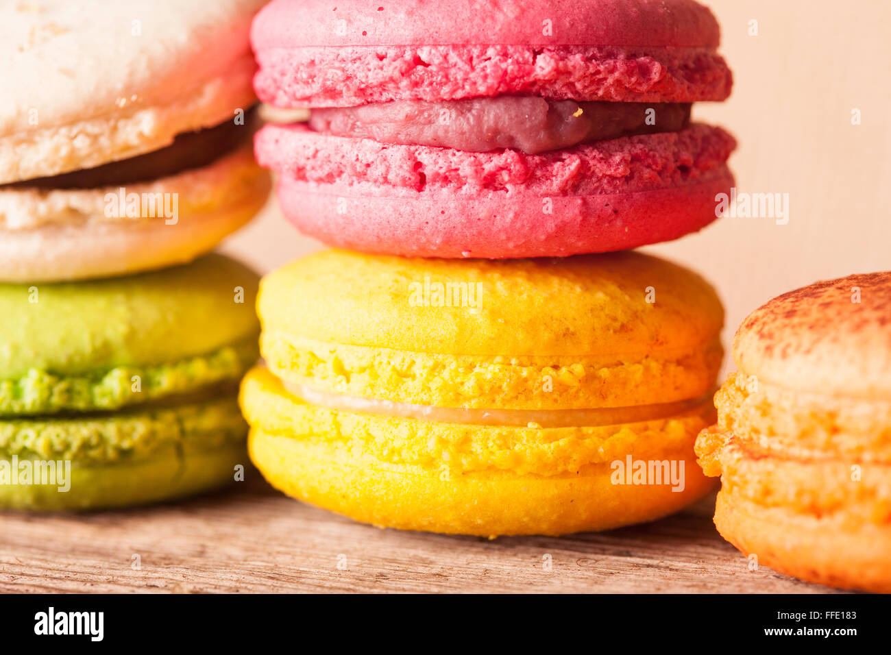Colorful French macaroons on a dark wooden background, selective focus ...
