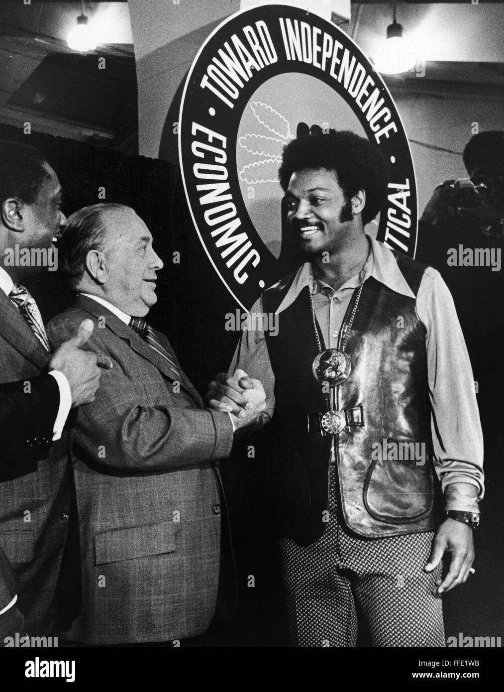 JESSE JACKSON (1941- ). /nAmerican civil rights leader. Jackson shaking ...