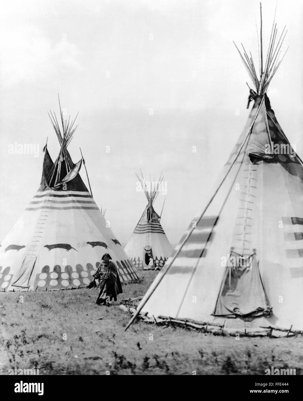 KAINAI VILLAGE, c1913. /nA Kainai woman walking among painted tepees ...