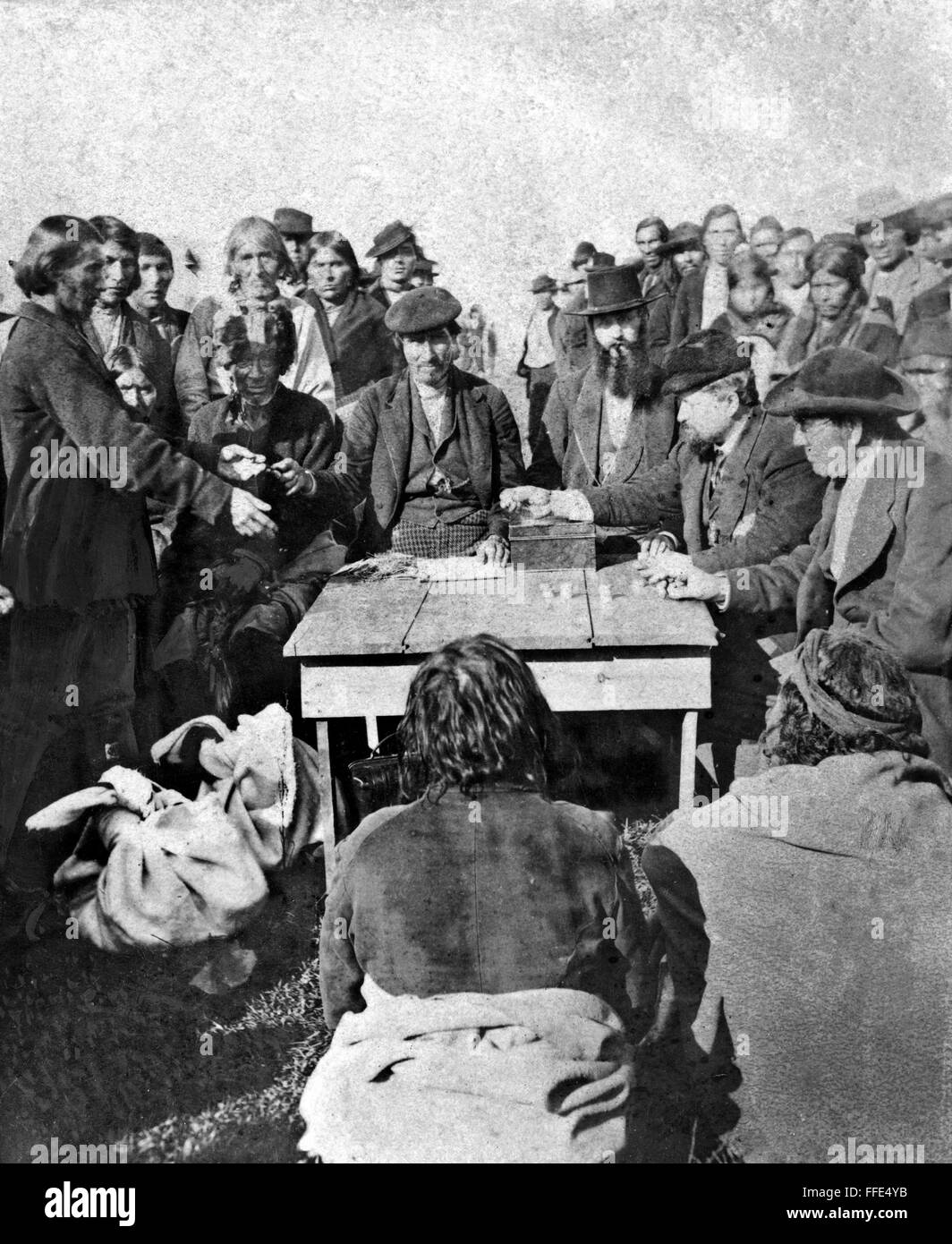 NATIVE AMERICAN TRADE. /nSeveral men seated around a table counting ...
