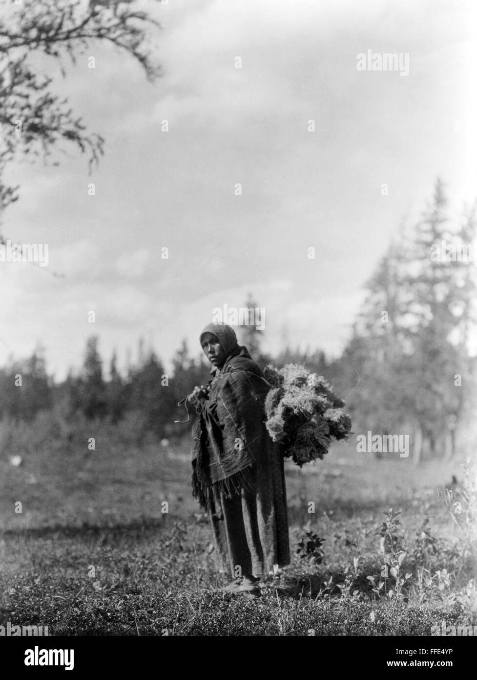 CREE WOMAN, c1927. /nA Cree Native American woman carrying a bundle of ...