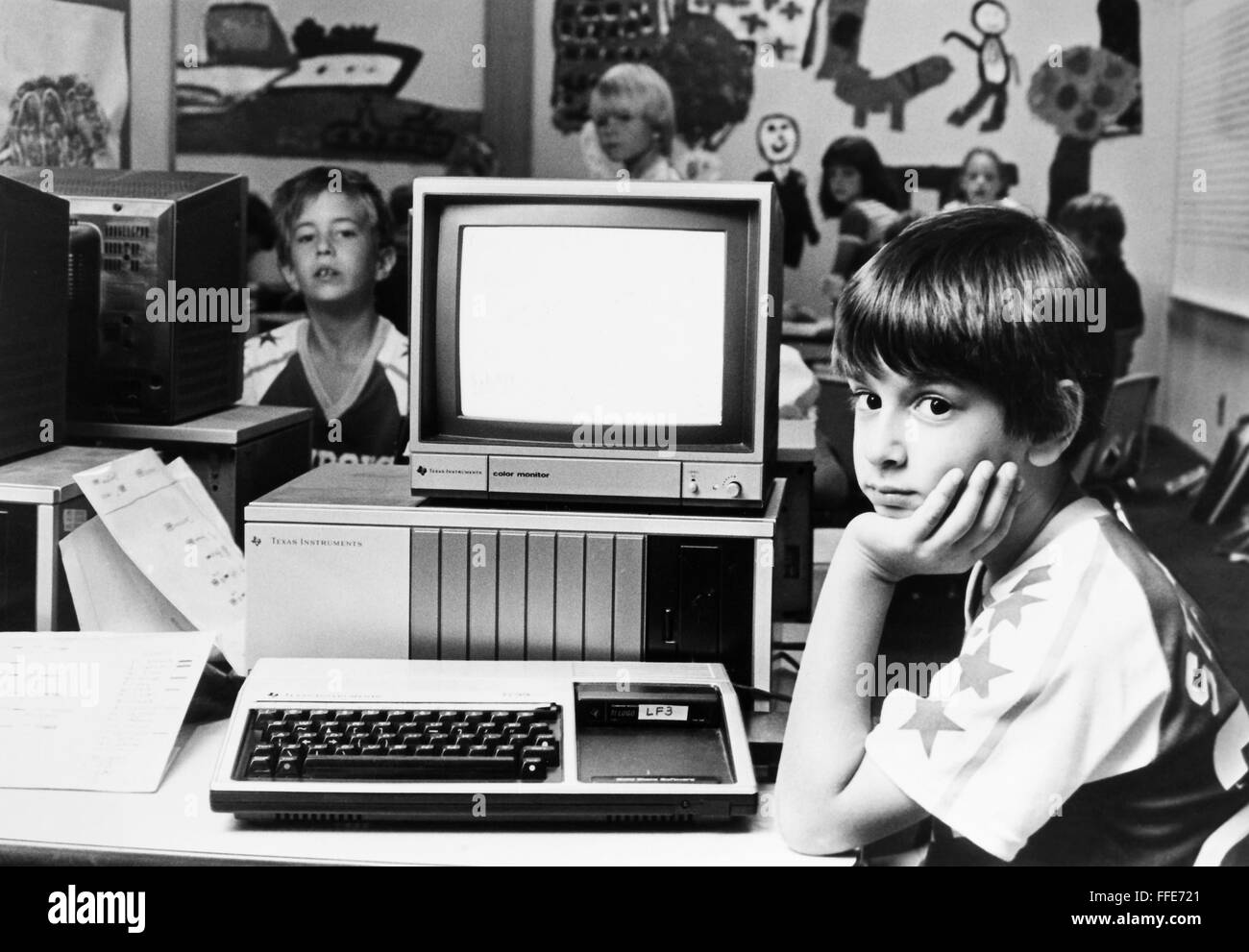 EDUCATION: COMPUTERS, 1983. /nAn 8-year-old boy seated beside a Texas ...