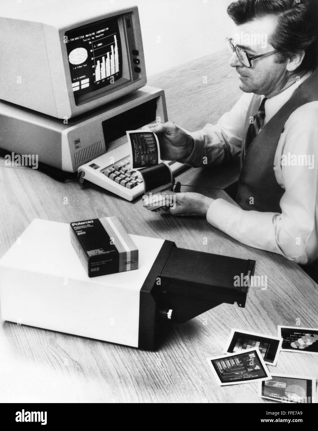 DIGITAL IMAGES, 1984. /nA computer user with photographic hard copies ...