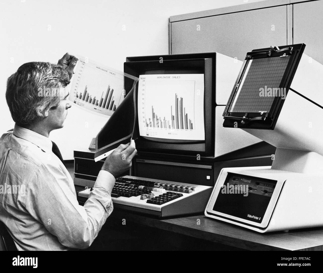 DIGITAL IMAGES, 1984. /nA computer user with an 8x10 transparency, made ...