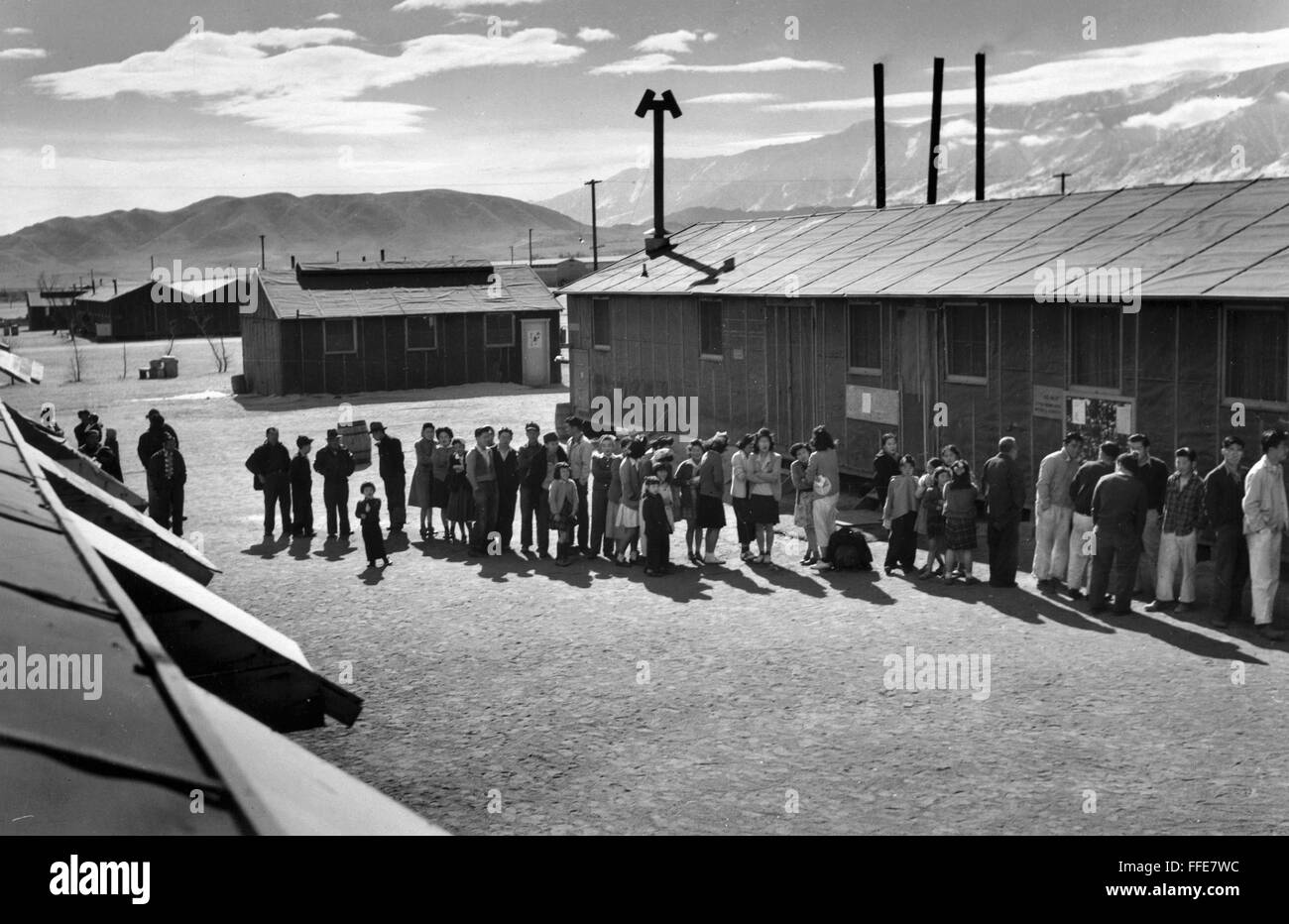 JAPANESE INTERNMENT, 1943. /nGroup of people waiting in line for food ...