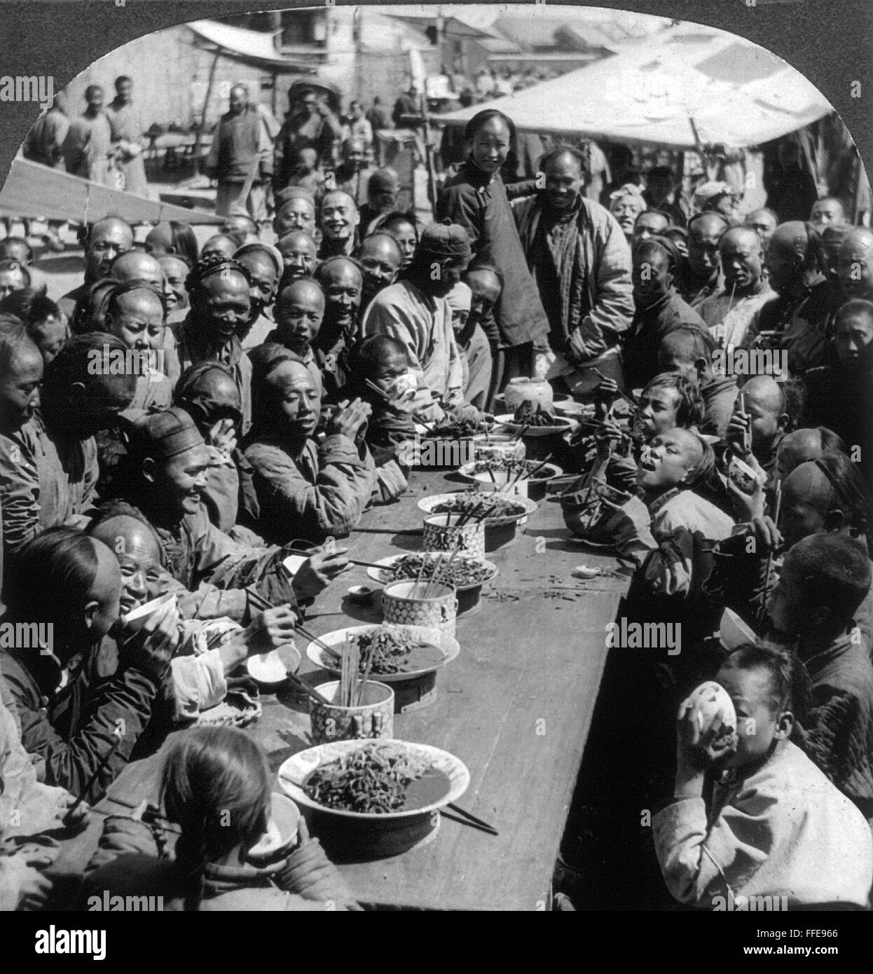 CHINA: RESTAURANT, c1924. /nA large group of men and children eating a ...