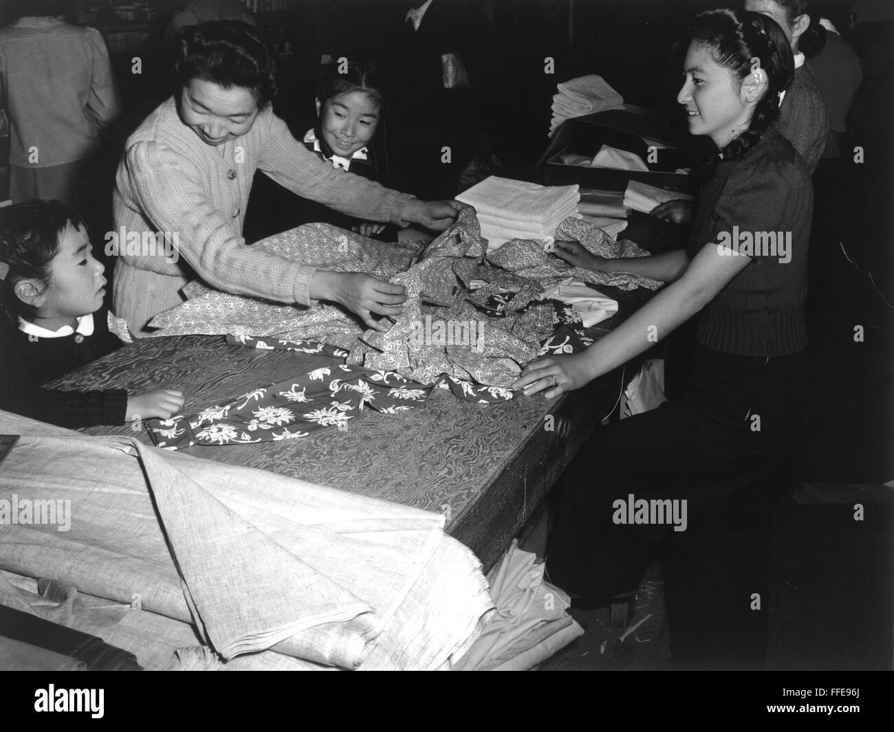 JAPANESE INTERNMENT, 1943. /nA Japanese American family buying clothing ...
