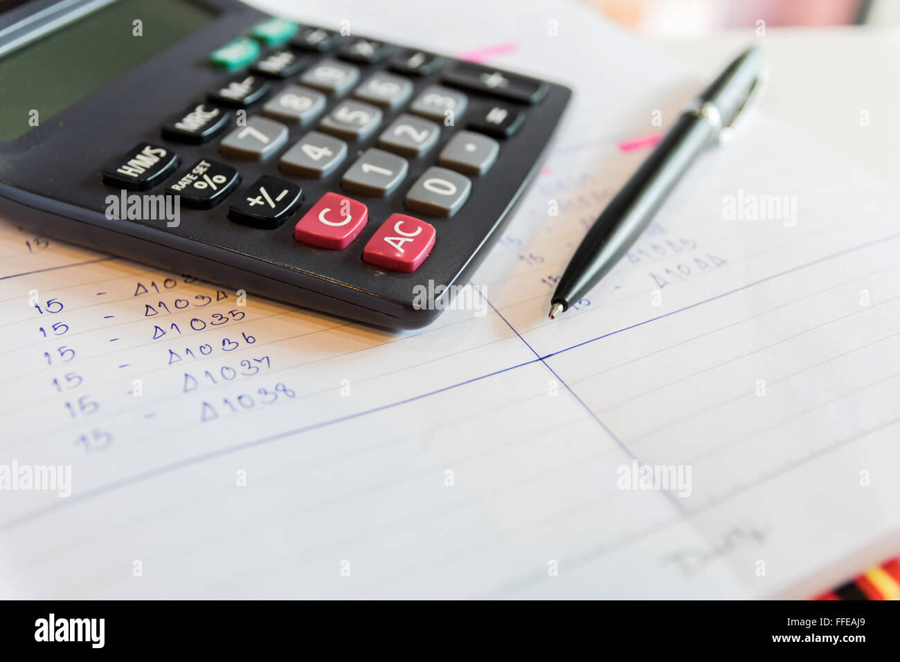 Calculator and pen devices in the calculations Stock Photo - Alamy