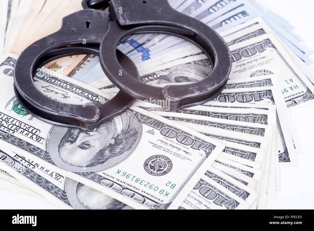 photo showing money with handcuffs Stock Photo - Alamy