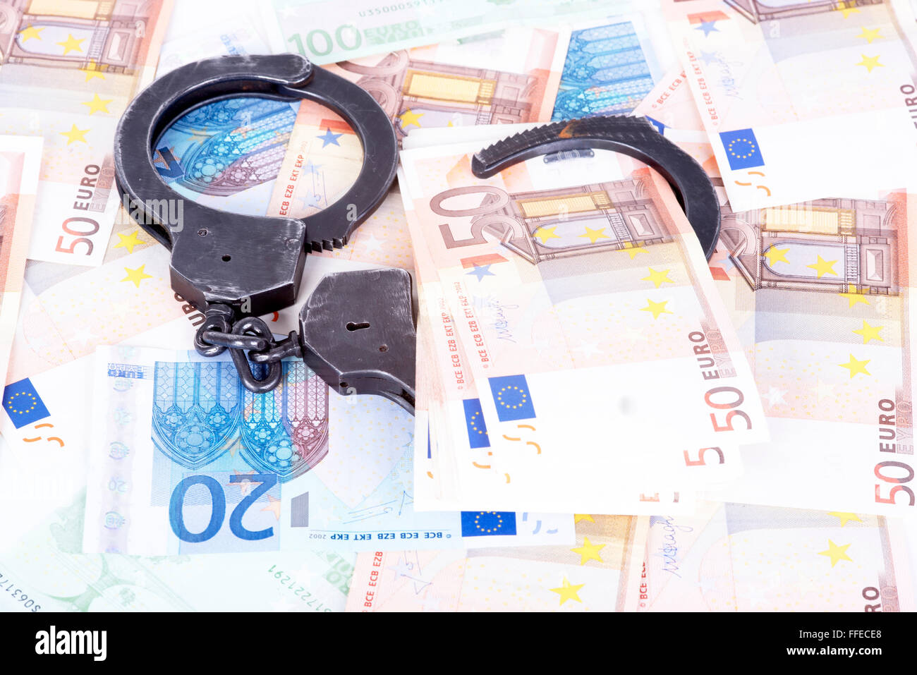 photo showing money with handcuffs Stock Photo - Alamy