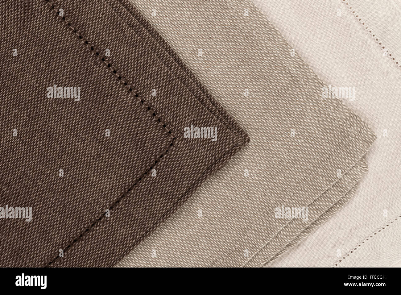 Edges of linen cloth napkins in brown and beige natural colors close up ...